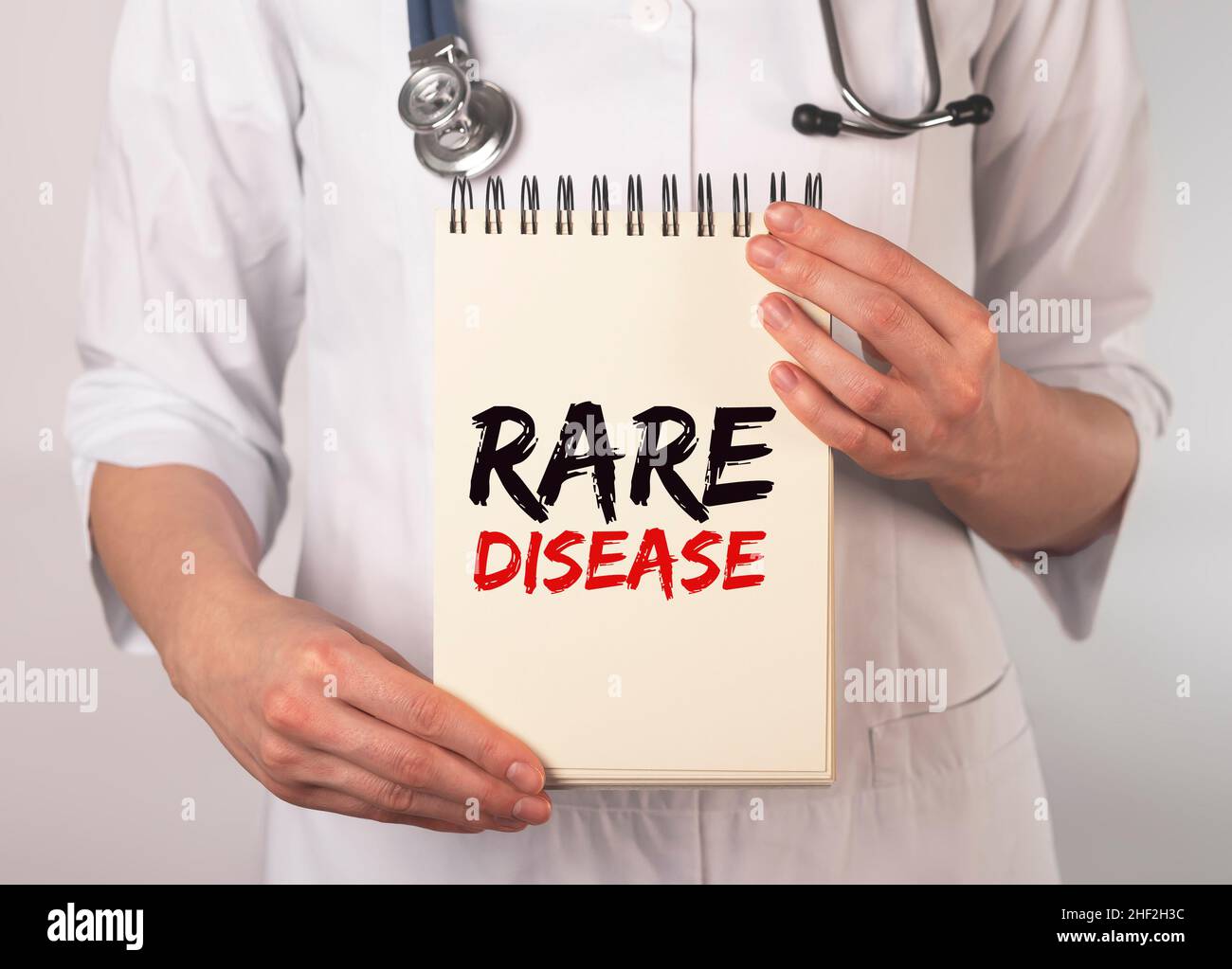 Rare disease day, text on paper in hand Stock Photo - Alamy