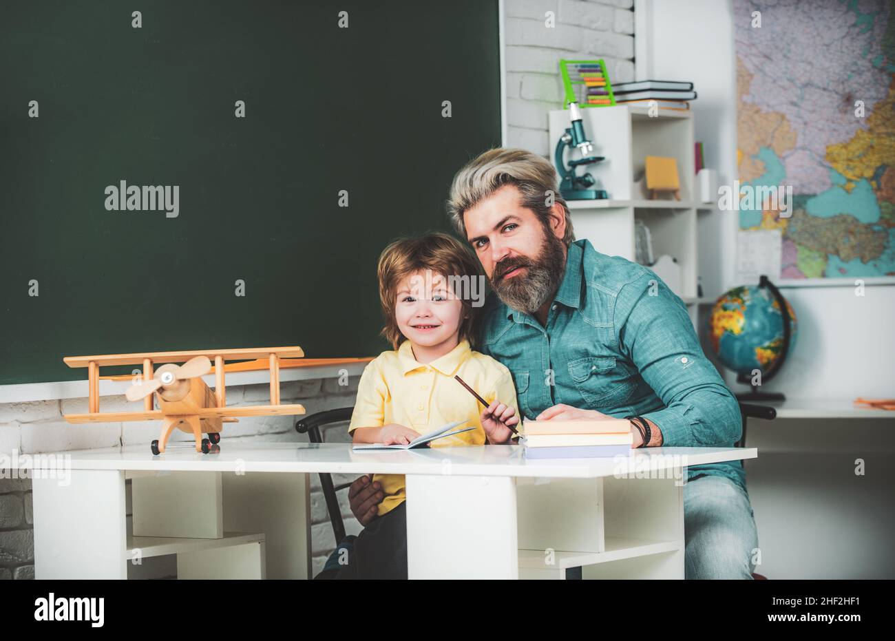 Kid gets ready for school. Home teacher or homework tutor. Homework ...