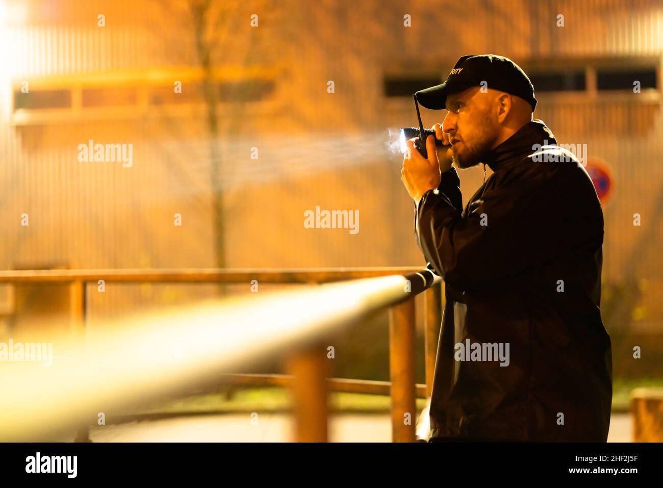 Security Guard Walking Outdoors With Flashlight At Night Stock Photo ...