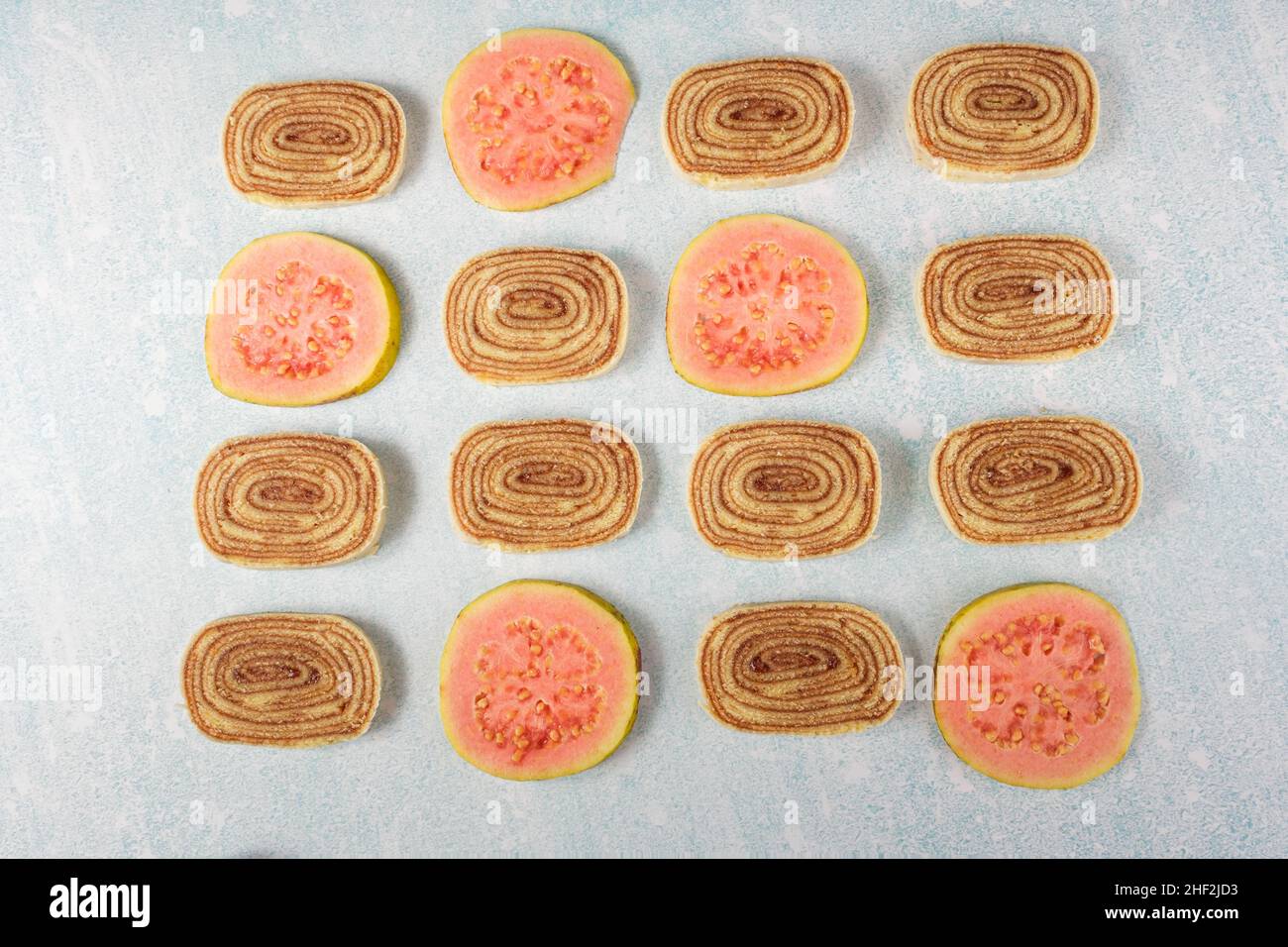 Bolo de rolo and guava slices on a blue and white background Stock ...