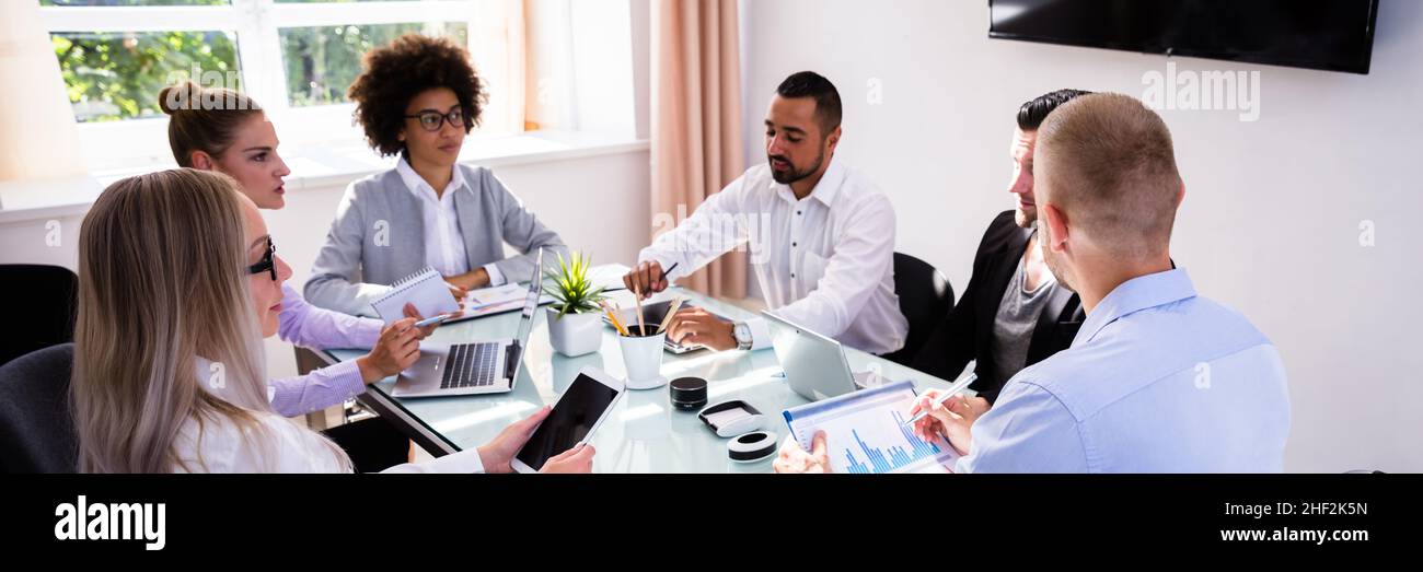 Business Team Working At Office Desk In Meeting Stock Photo - Alamy