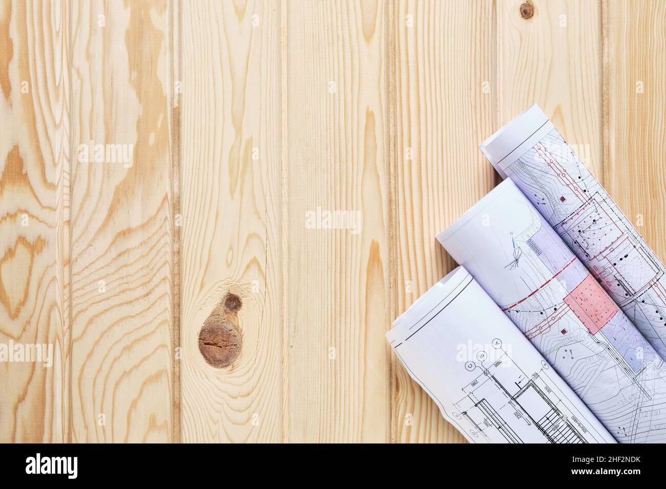 Rolled drawings at wooden background Stock Photo - Alamy