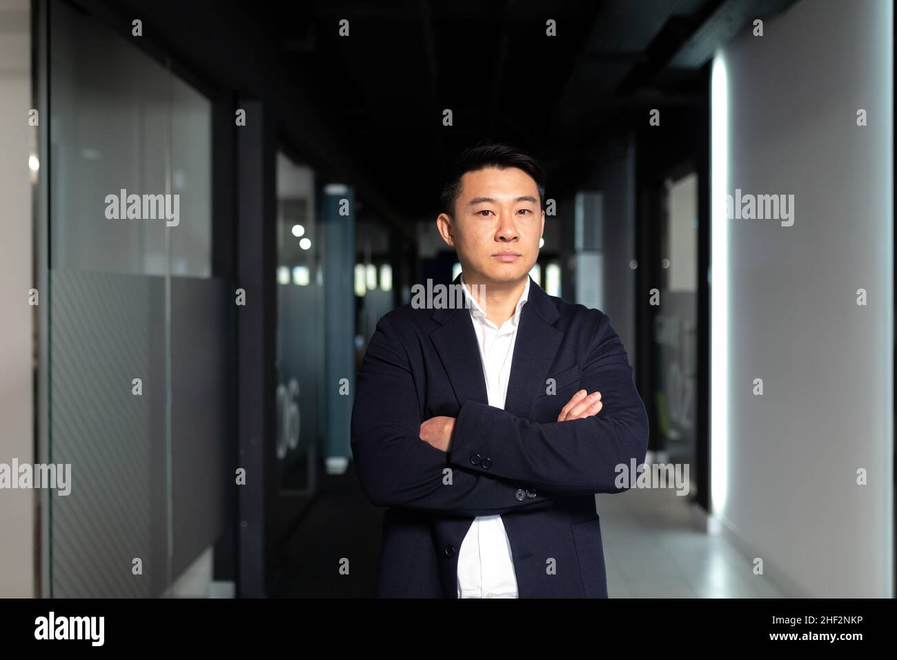 Portrait of a successful Asian manager boss, with crossed arms in a ...