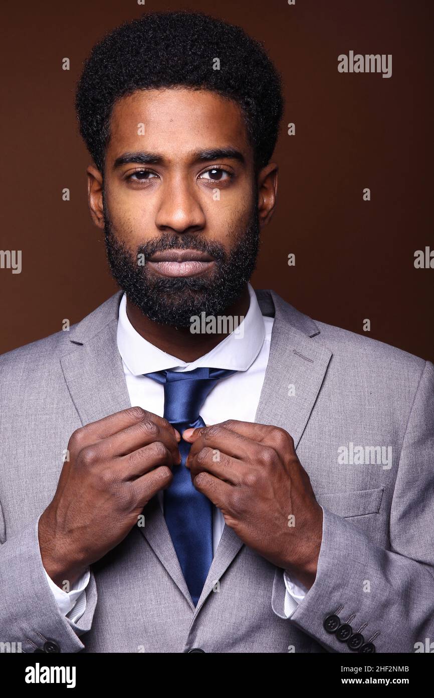Portrait of a beautiful happy man in front of a colored background ...