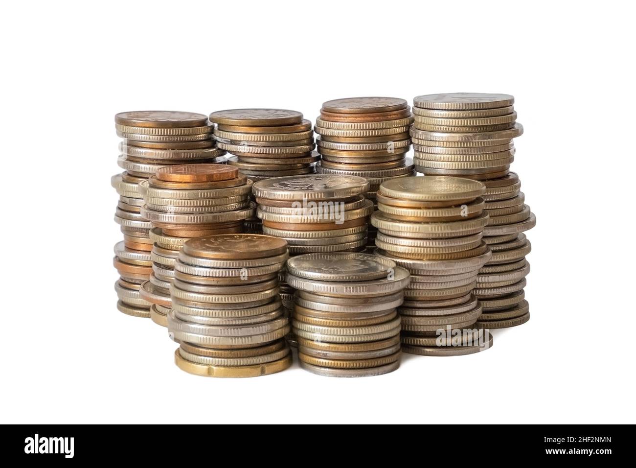 Many stacks of different coins isolated on white background. Business ...