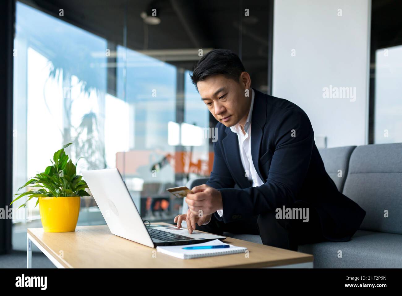 Man working on computer contemplating hi-res stock photography and ...