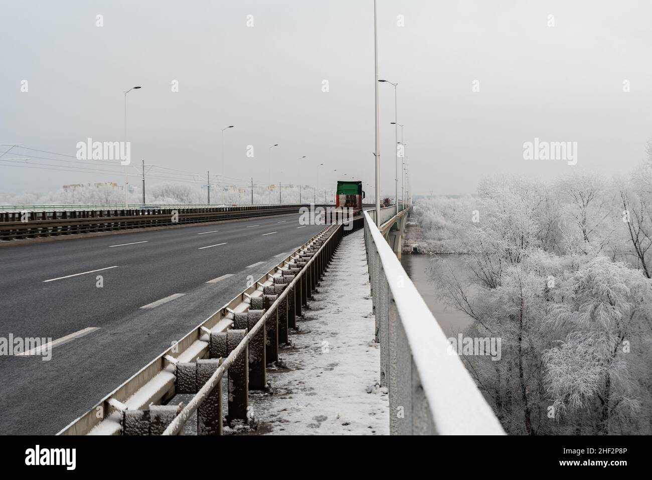Warsaw, Poland - December 14, 2021: Bridge, road and trees covered with ...