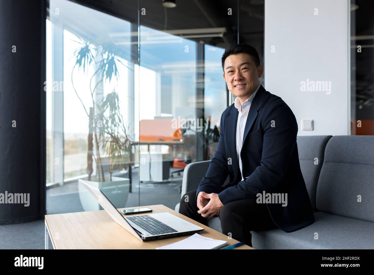 Successful and happy asian man working online remotely on laptop ...