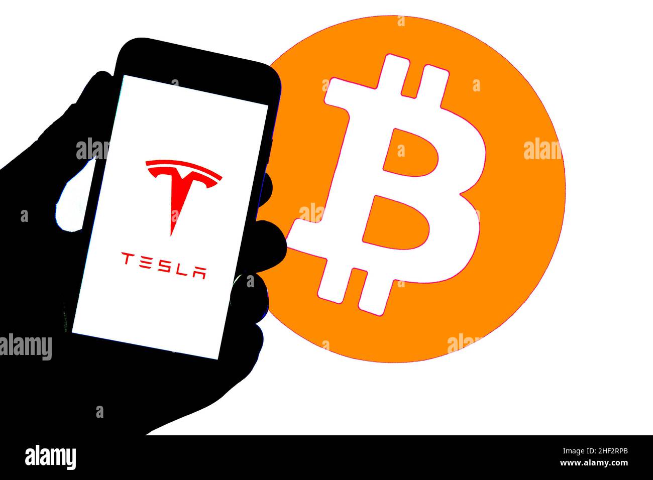 In this photo illustration a Tesla logo seen displayed on a smartphone ...