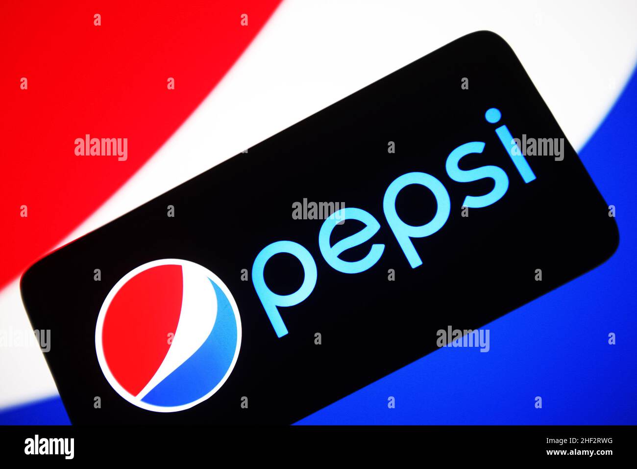 In this photo illustration, a Pepsi logo is seen on a smartphone and a ...