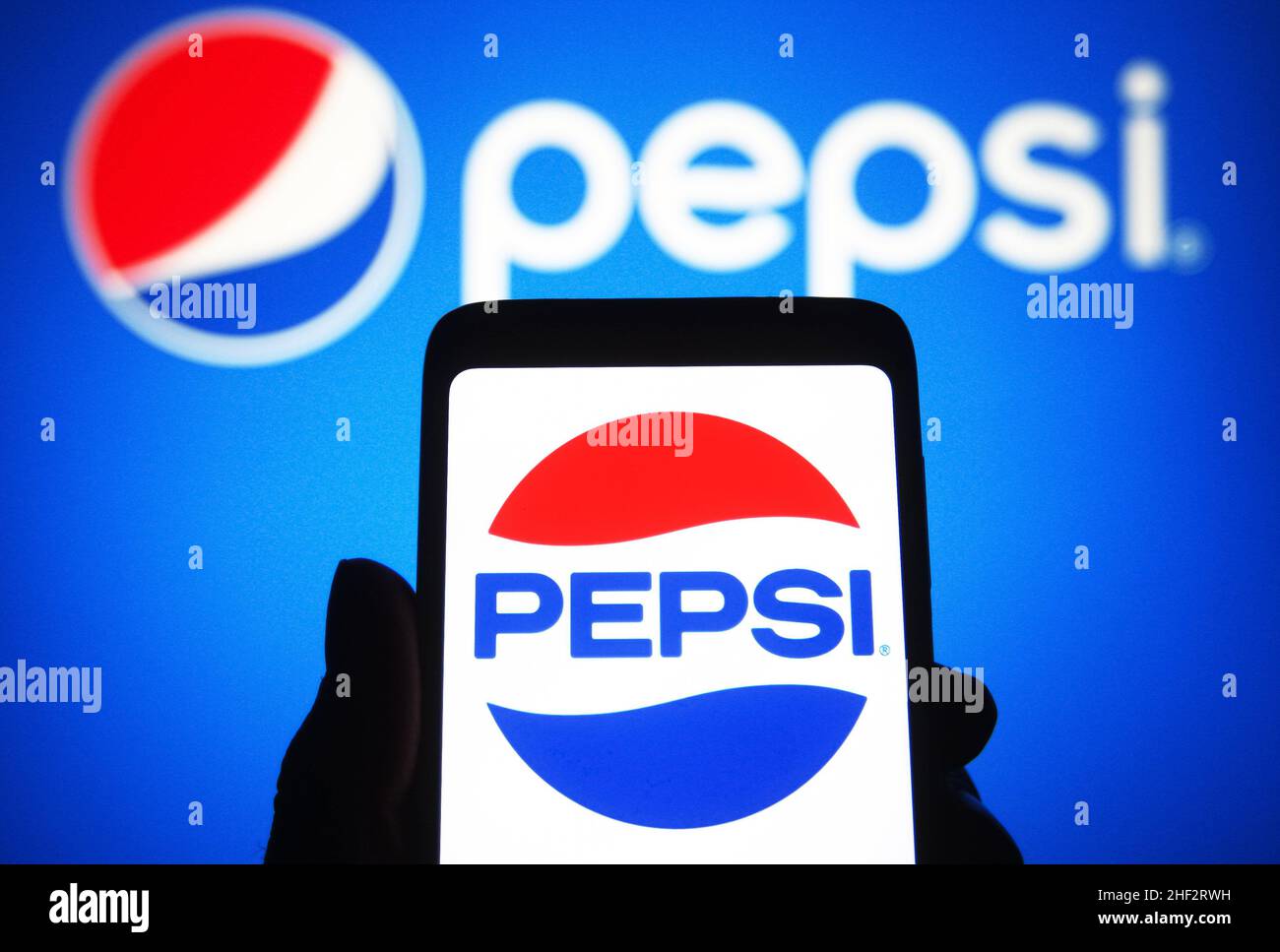 In this photo illustration, a Pepsi logo is seen on a smartphone and a ...