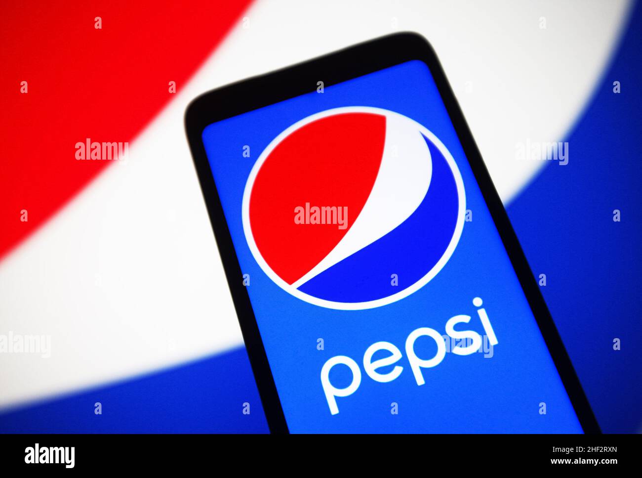 In this photo illustration, a Pepsi logo is seen on a smartphone and a ...