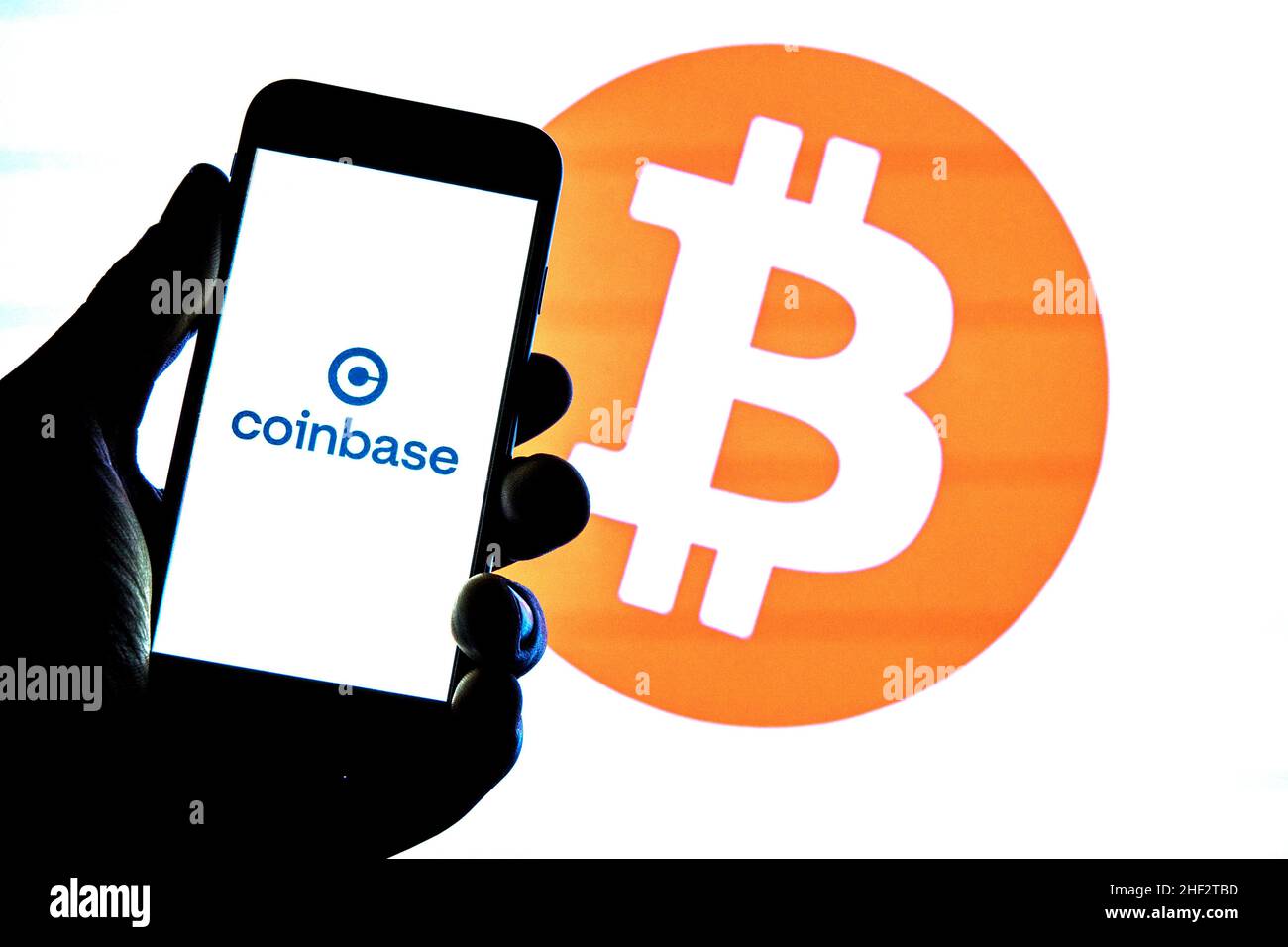 In this photo illustration a Coinbase logo seen displayed on a ...