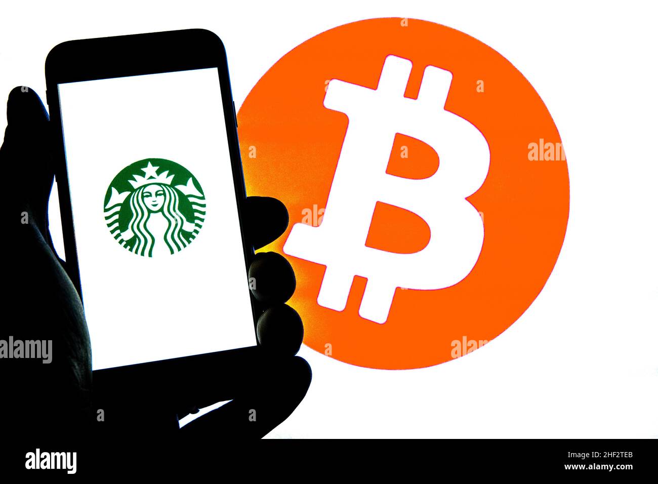 In this photo illustration a Starbucks logo seen displayed on a ...
