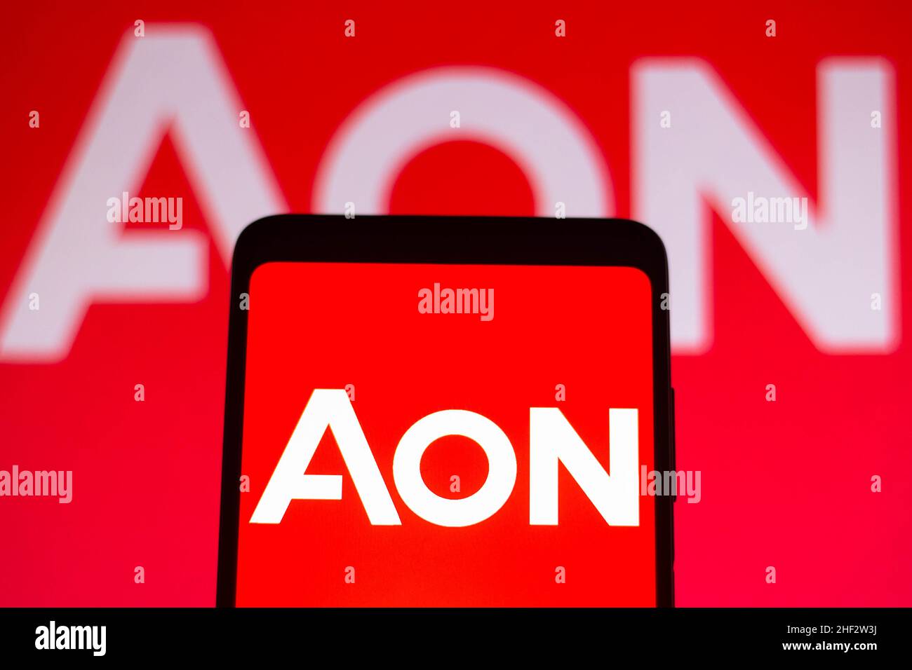 In this photo illustration, an Aon plc logo is seen displayed on a ...