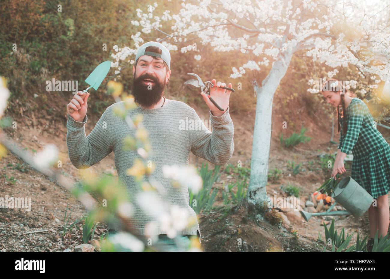 Funny Gardener work in yard with garden tools and have good time ...