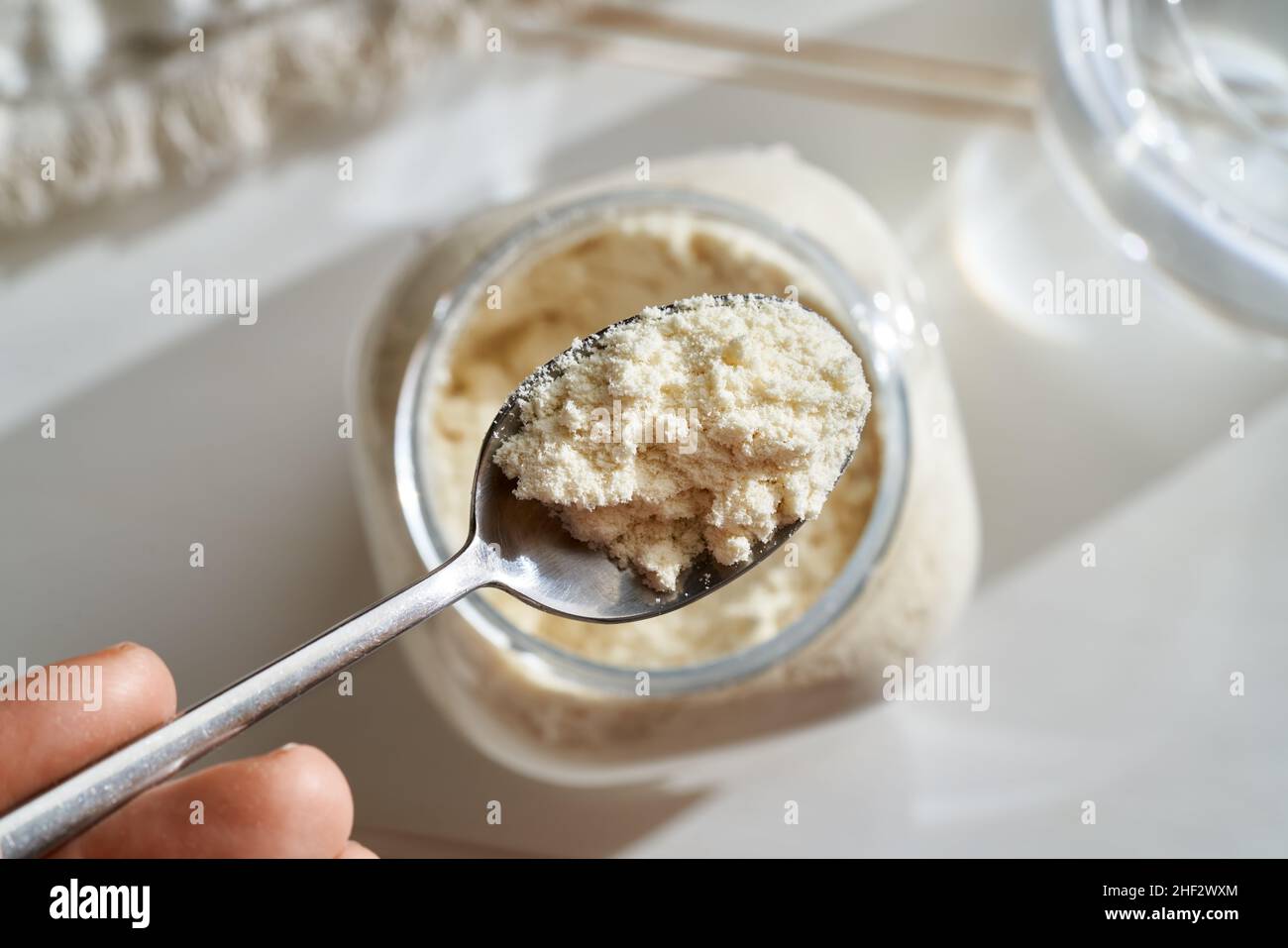 Whey protein powder on a metal spoon - ingredient for a healthy fitness ...