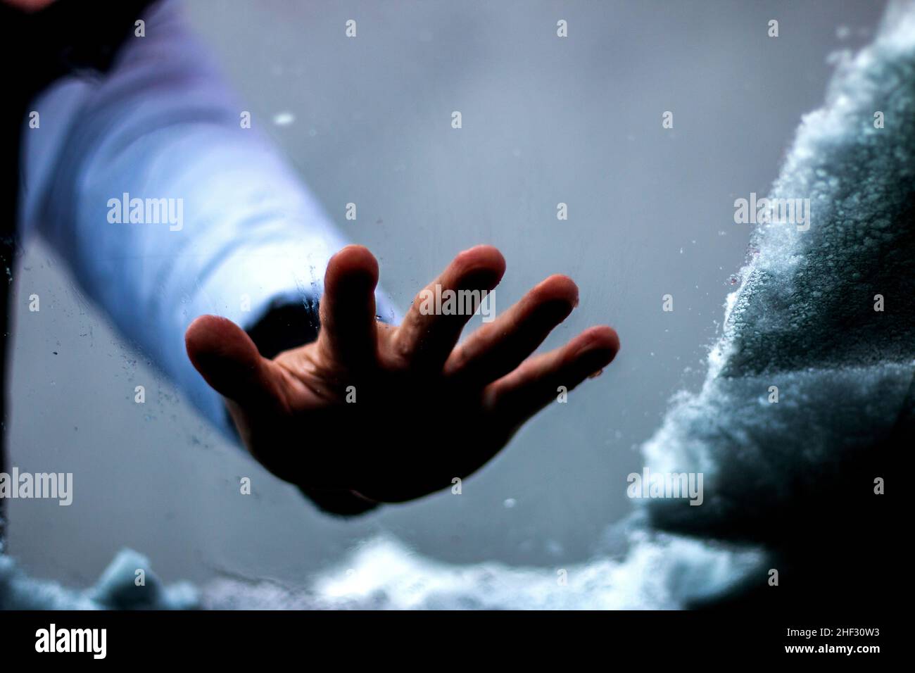 Close-up hand on the window. Man looks through frosted glass Stock ...