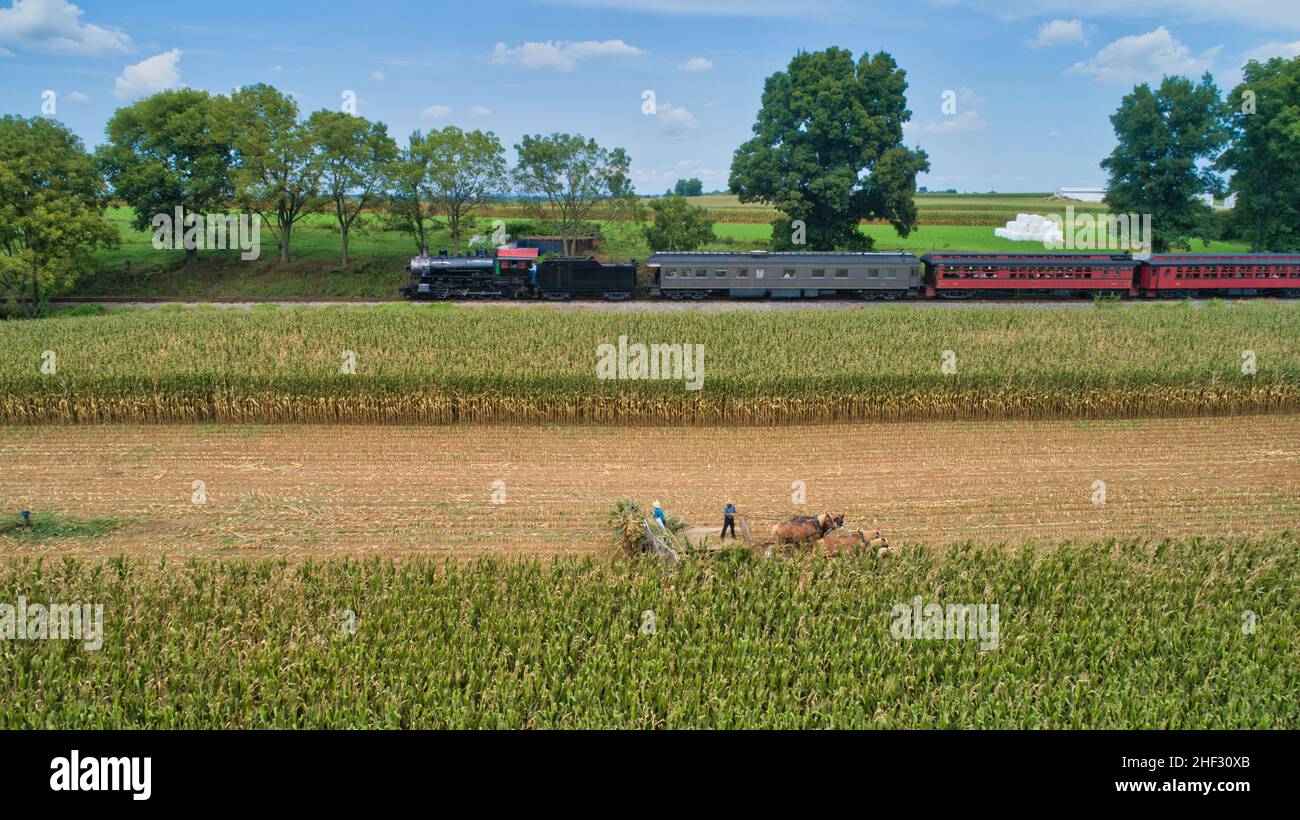Aerial View of a Antique Steam Passenger Train Going By While Amish ...