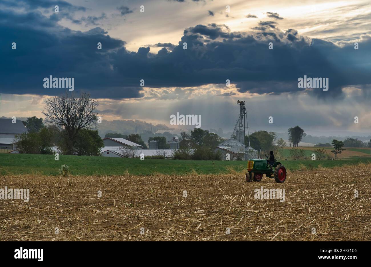 An Antique Farm Tractor Sitting in a Harvested Field Waiting, With a ...