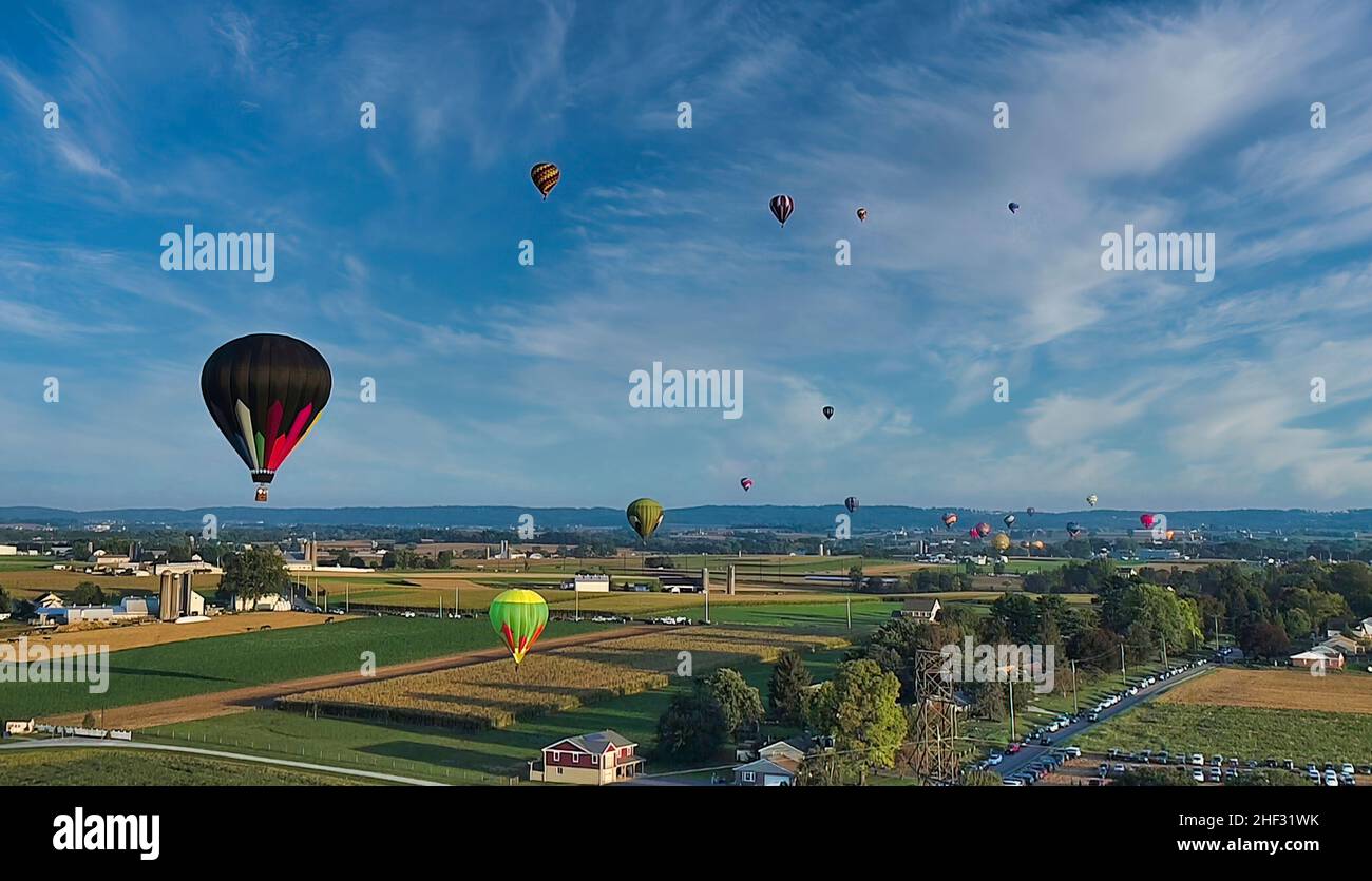 Aerial View of Many Hot Air Balloons Flying Across Rural Countryside ...