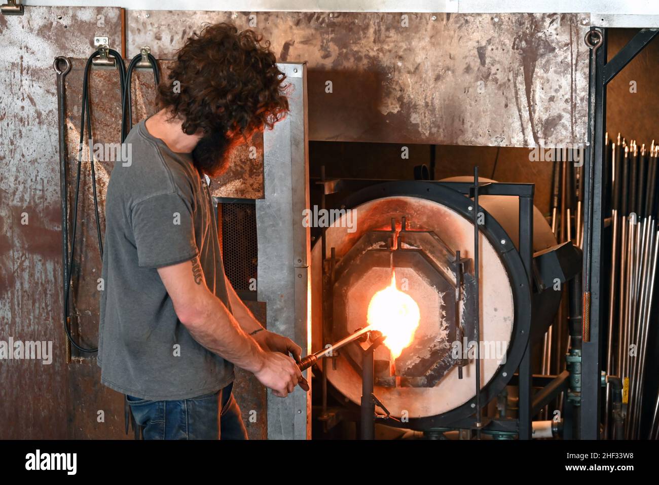 Staff heat up glass in a furnace at the Lexington Glassworks in ...
