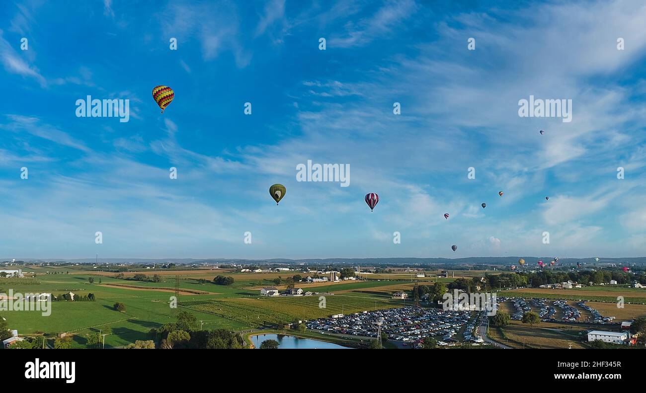 Aerial View of Many Hot Air Balloons Flying Across Rural Countryside ...