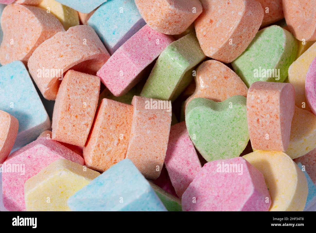 Powdered candies in various colors and shapes. Sweets for children ...