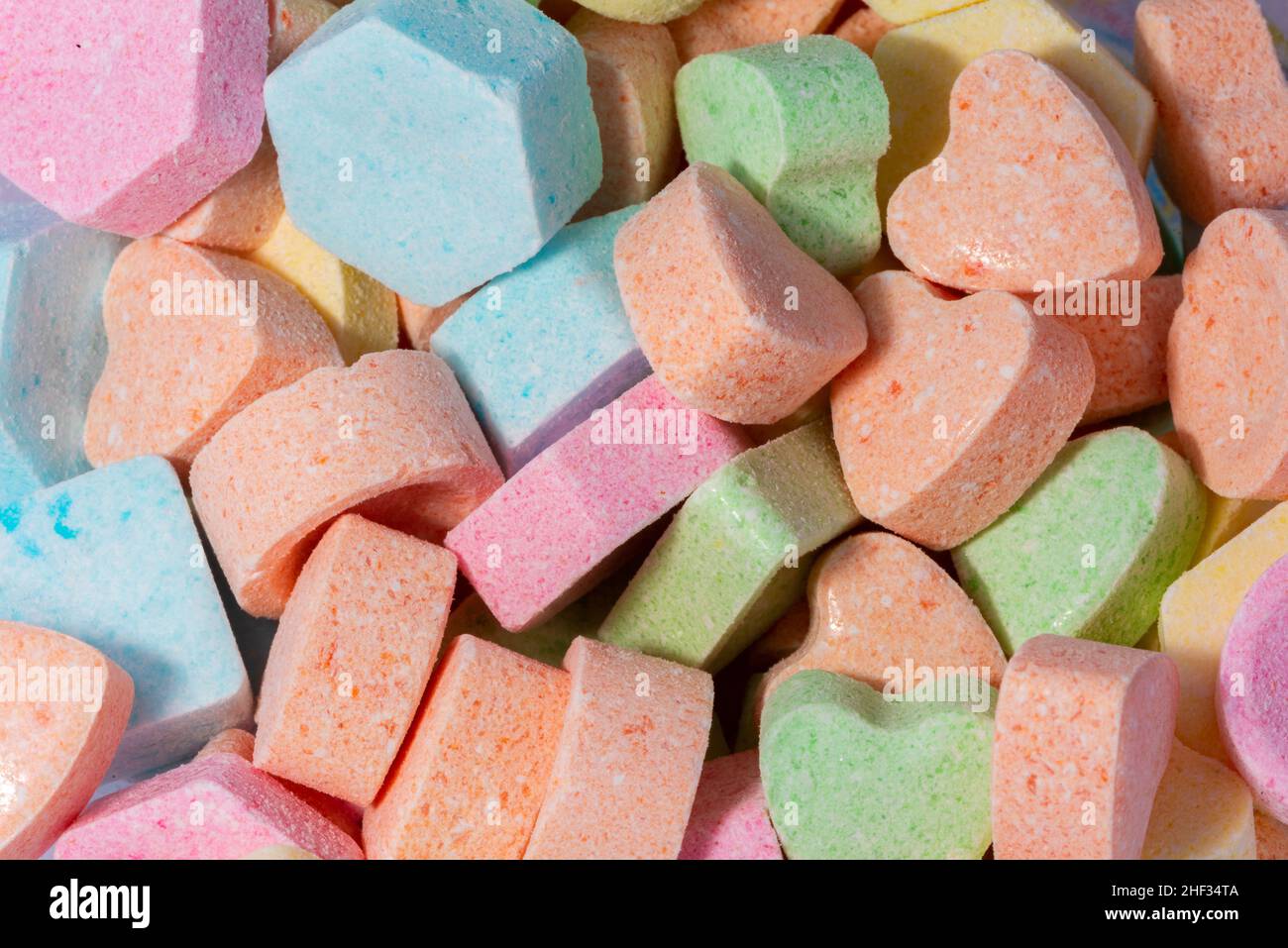 Powdered candies in various colors and shapes. Sweets for children ...