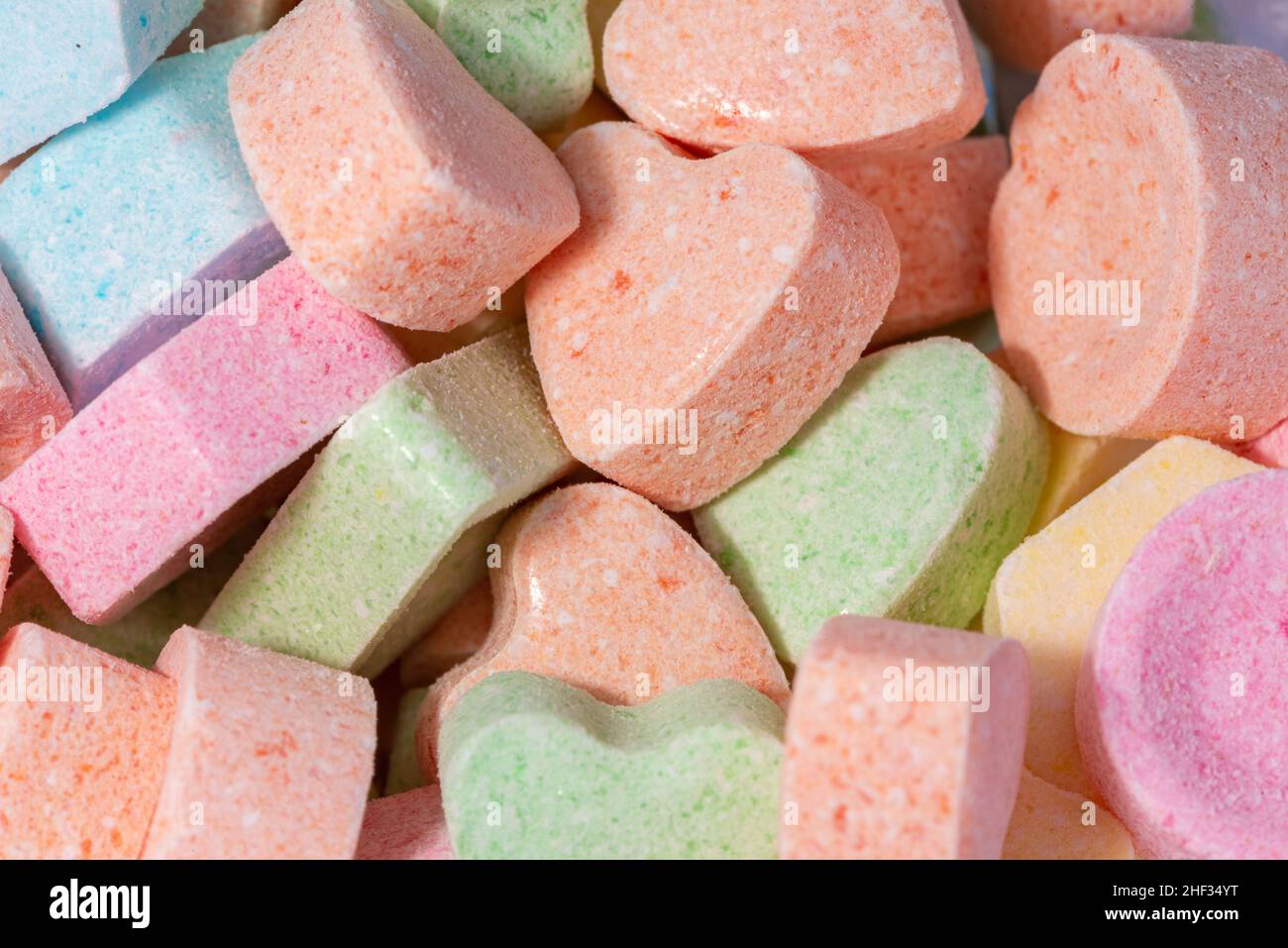 Powdered candies in various colors and shapes. Sweets for children ...