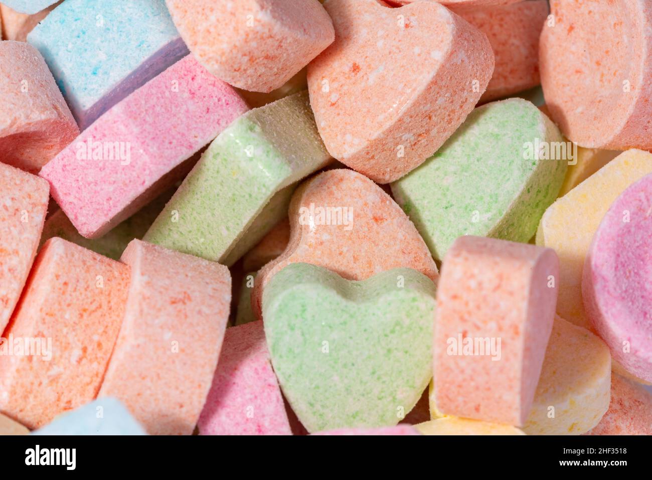 Powdered candies in various colors and shapes. Sweets for children ...