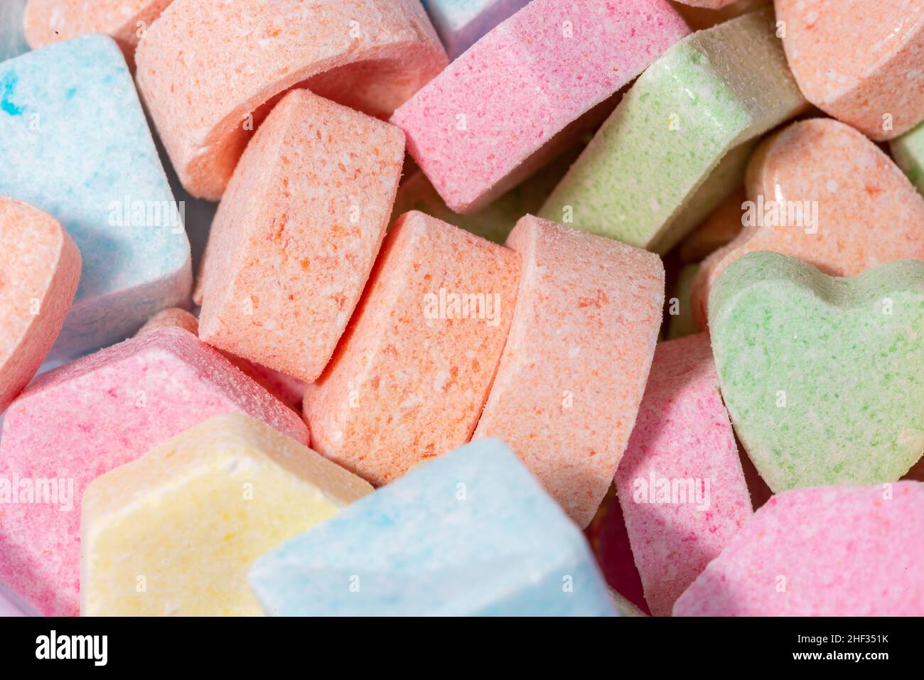 Powdered candies in various colors and shapes. Sweets for children ...