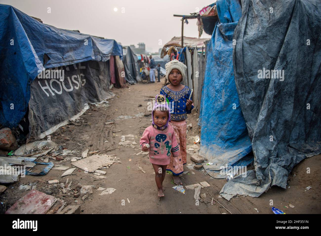 Children seen walking barefooted through a narrow lane amid cluster of ...