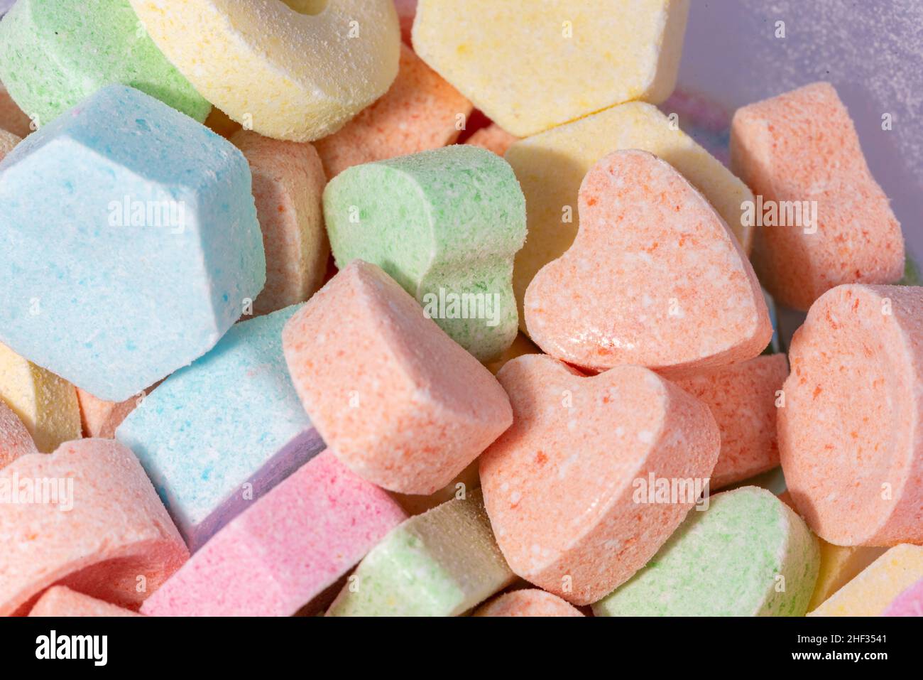 Powdered candies in various colors and shapes. Sweets for children ...