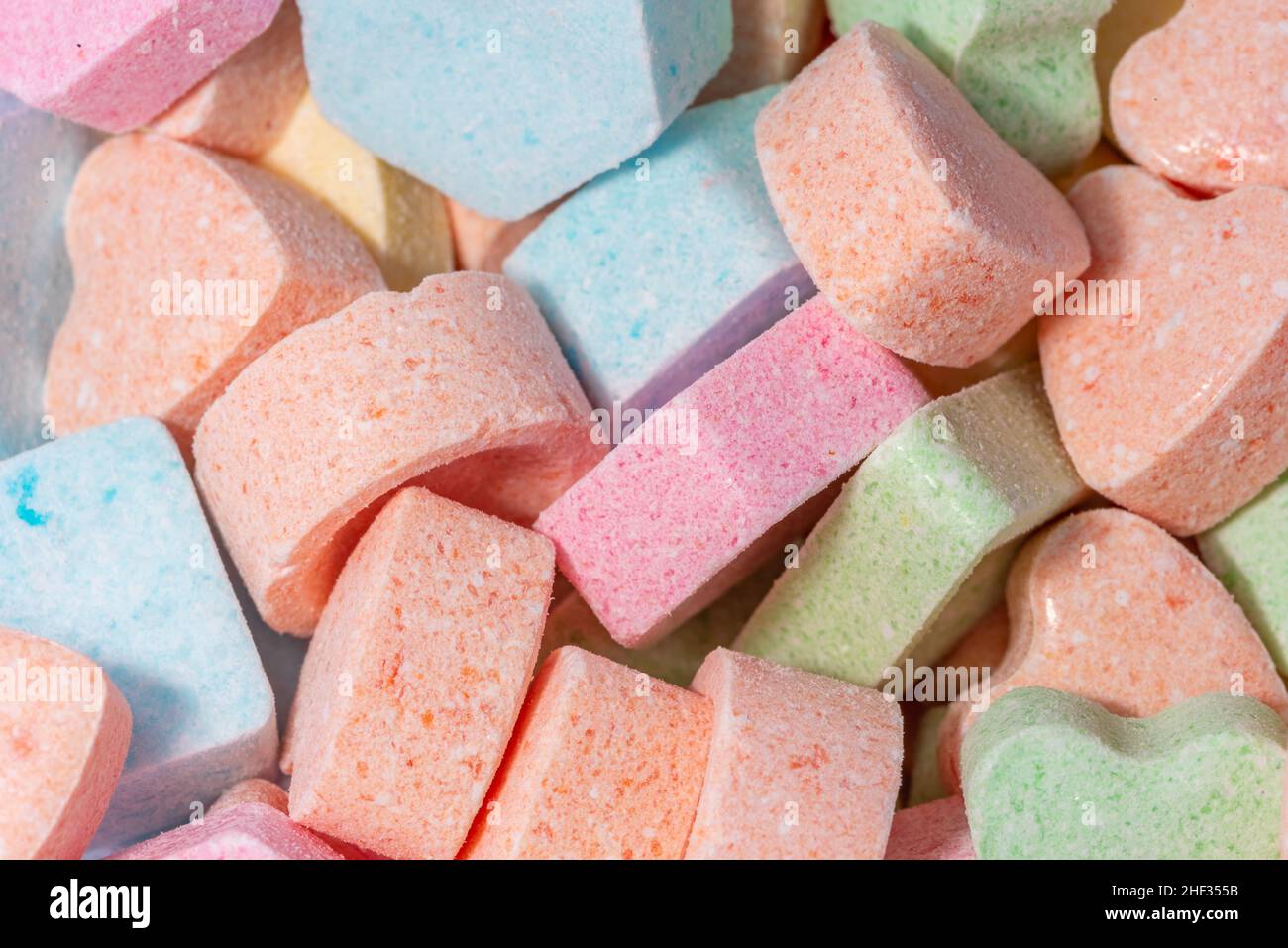 Powdered candies in various colors and shapes. Sweets for children ...