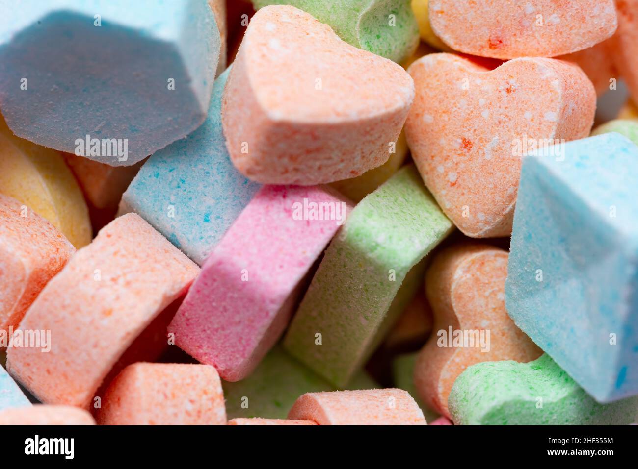 Powdered candies in various colors and shapes. Sweets for children ...