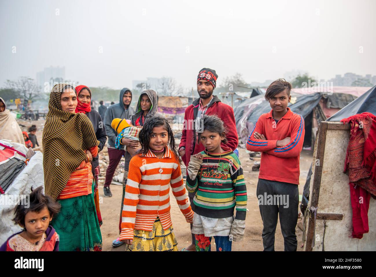 Ghaziabad, India. 13th Jan, 2022. Slum dwellers seen standing together ...