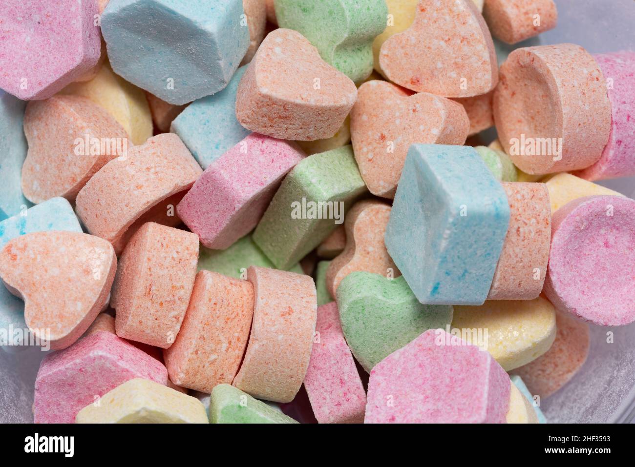 Powdered candies in various colors and shapes. Sweets for children ...