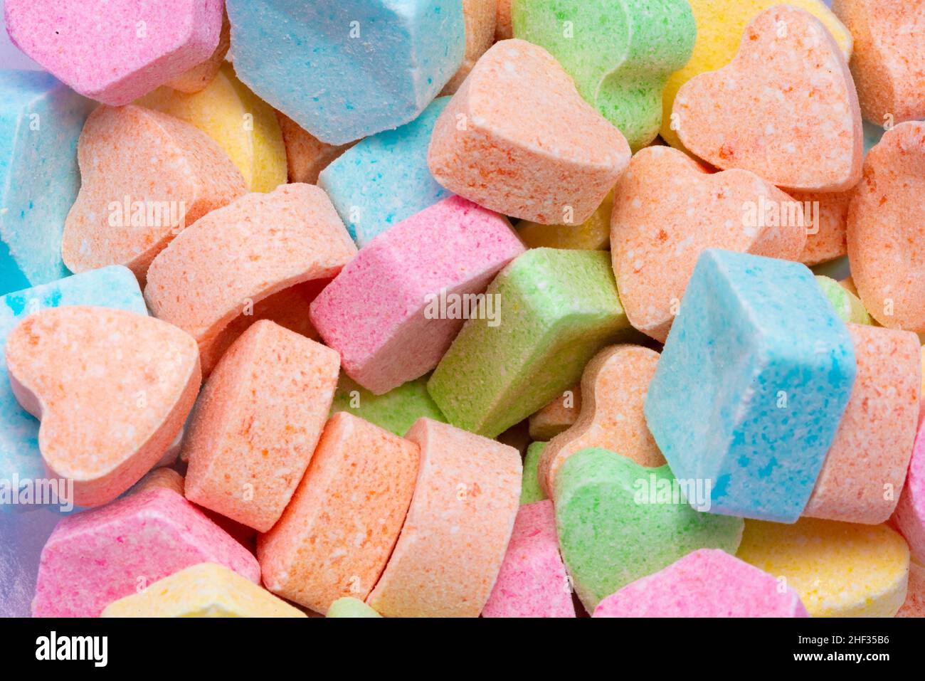 Powdered candies in various colors and shapes. Sweets for children ...