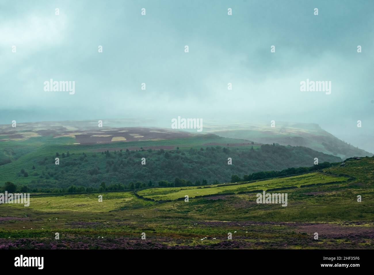 Vast landscape of Peak District hills covered with clouds and fog ...