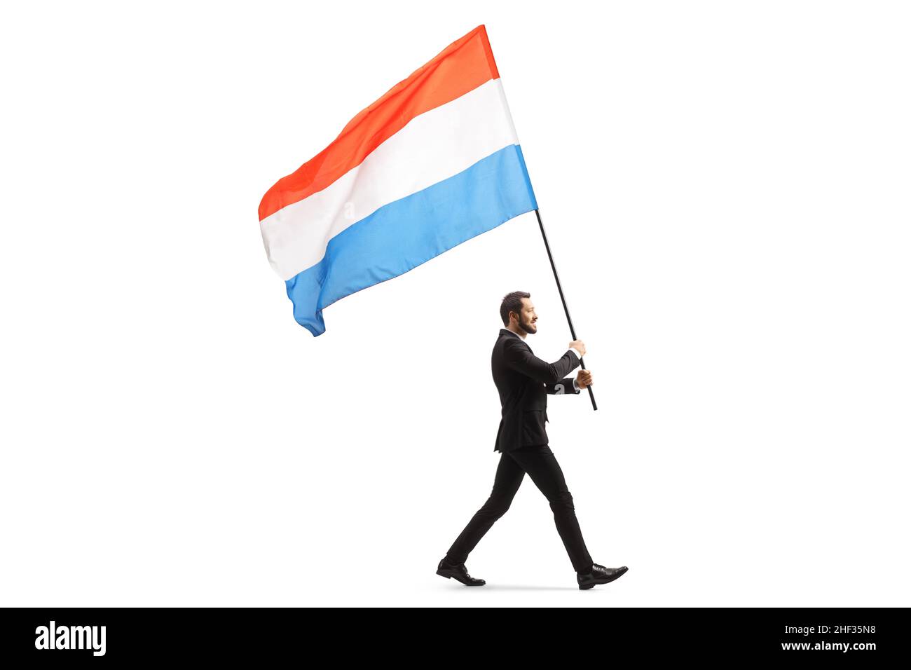 Full length profile shot of an elegant man in a suit walking and ...