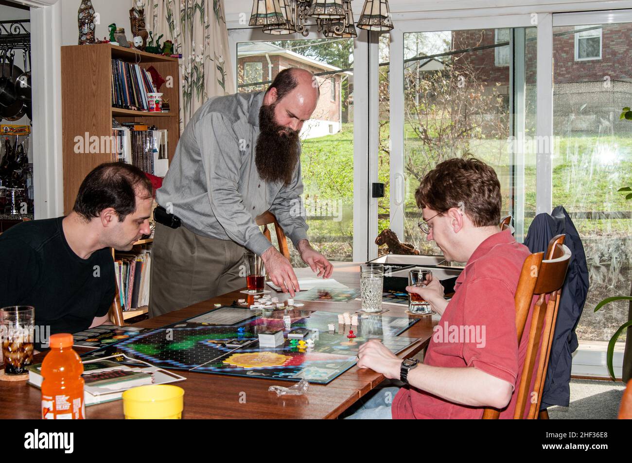 Three gamers in St. Louis, Missouri, USA, play a board game Stock Photo ...