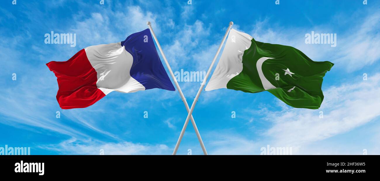 crossed national flags of France and Pakistan flag waving in the wind ...