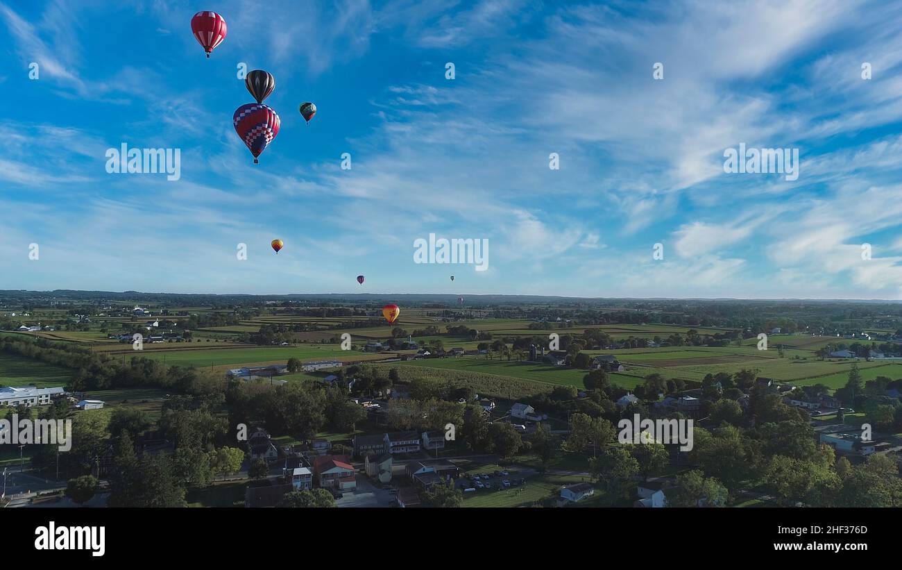 Aerial View of Many Hot Air Balloons Flying Across Rural Countryside ...