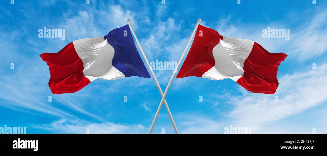 crossed national flags of France and Peru flag waving in the wind at ...