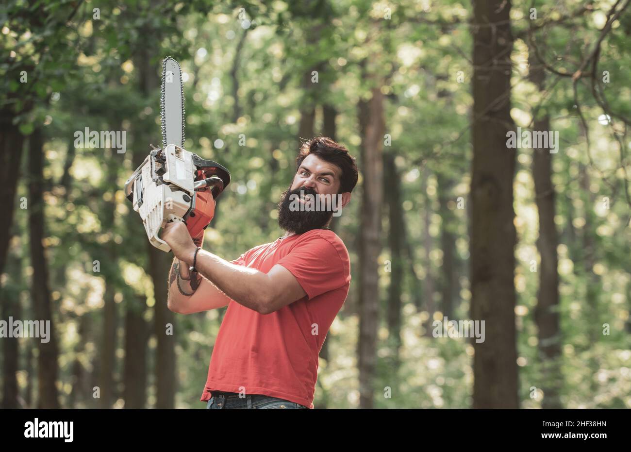 Lumberjack worker with chainsaw in the forest. Lumberjack worker ...