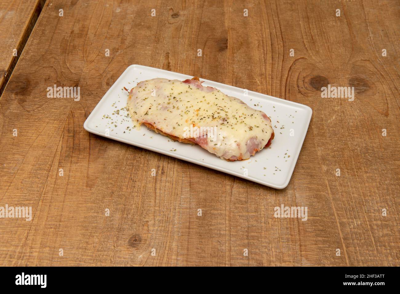 Milanesa, covered with cow cheese and oregano, is a fillet, usually of ...