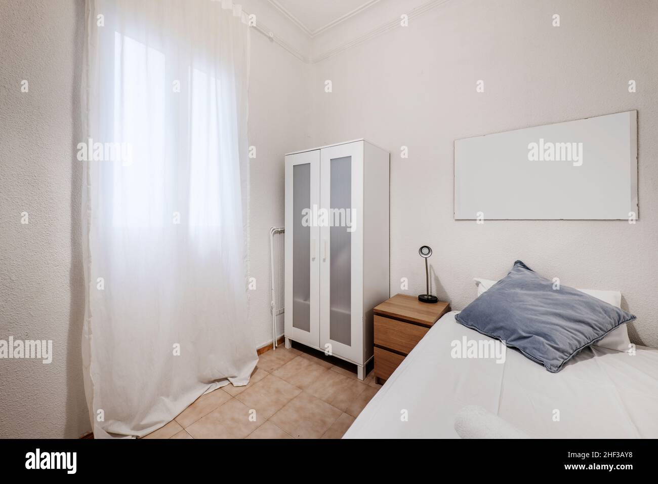 Shabby bedroom with white wardrobe and white drapery covering the ...