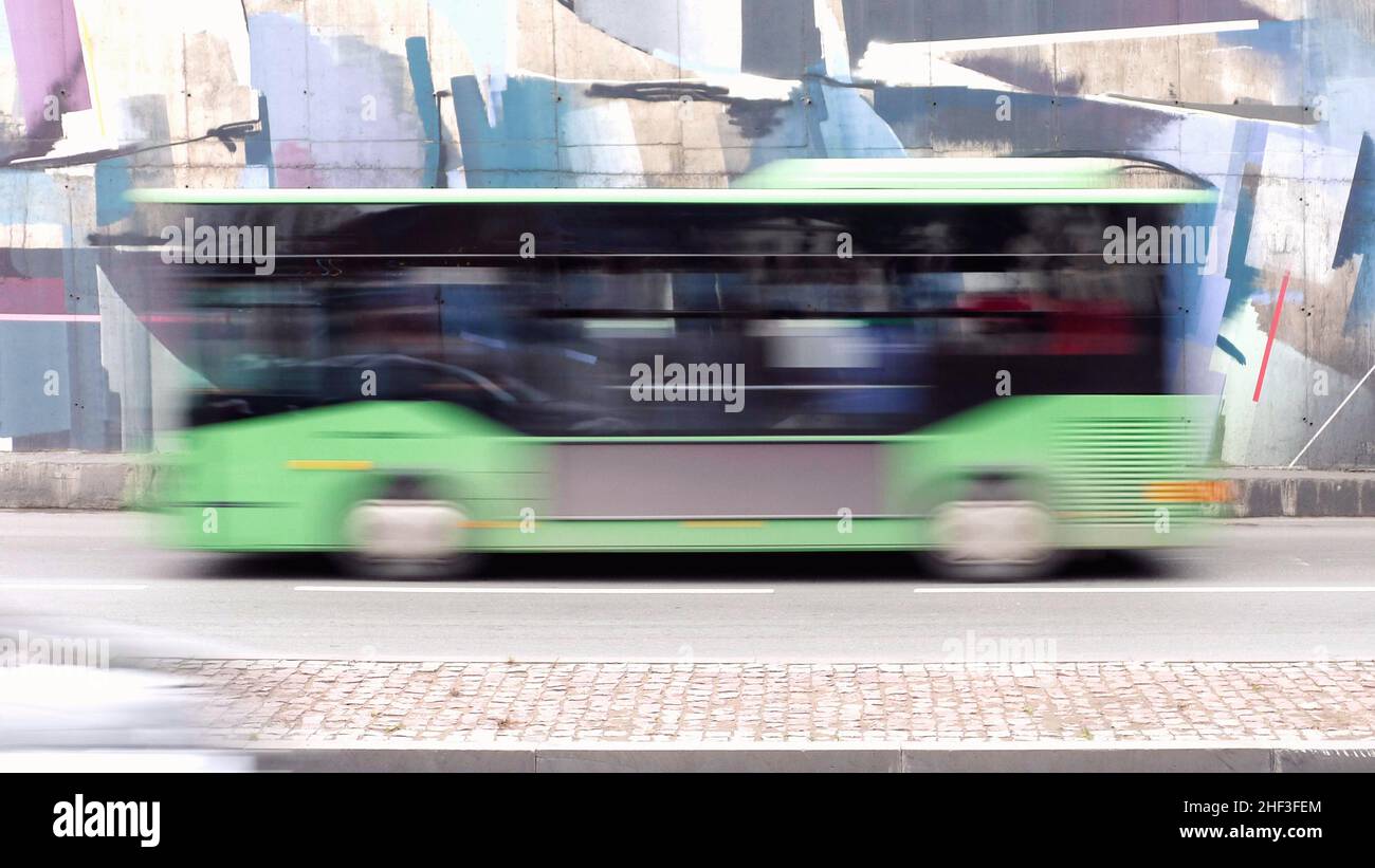 Motion blur image of a green bus moving fast Stock Photo - Alamy