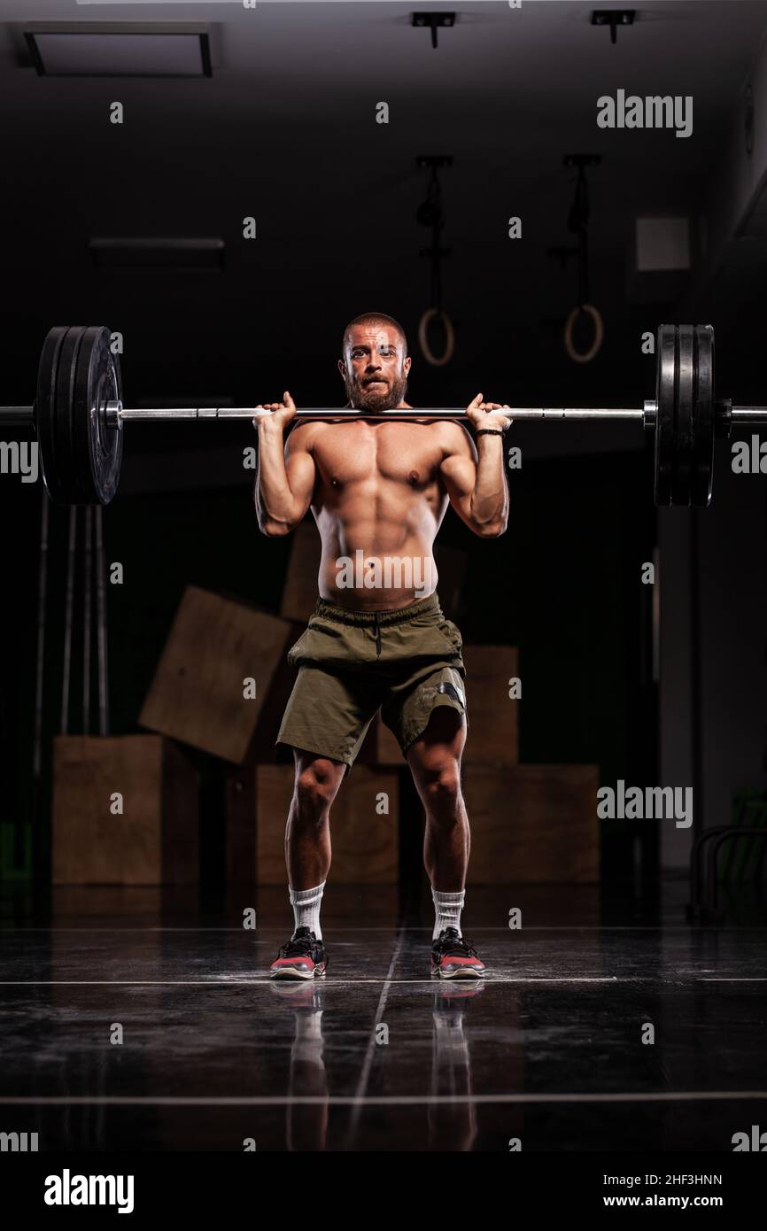 Muscular athlete lifting very heavy barbell Stock Photo - Alamy